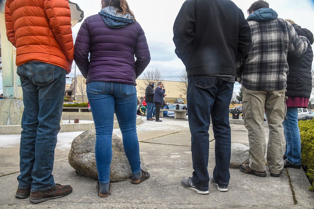 Deacon Roy Buck led the socially distanced group in their quiet Hail ...