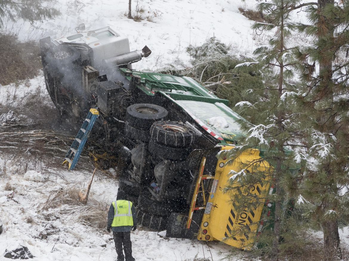 Trash collector injured after garbage truck falls down embankment near ...